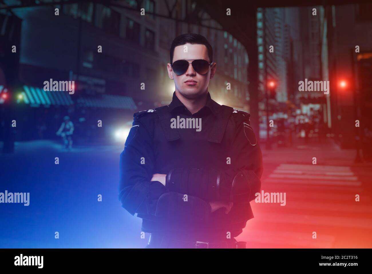Seriuse cop in sunglasses and black uniform with body armor, night city ...