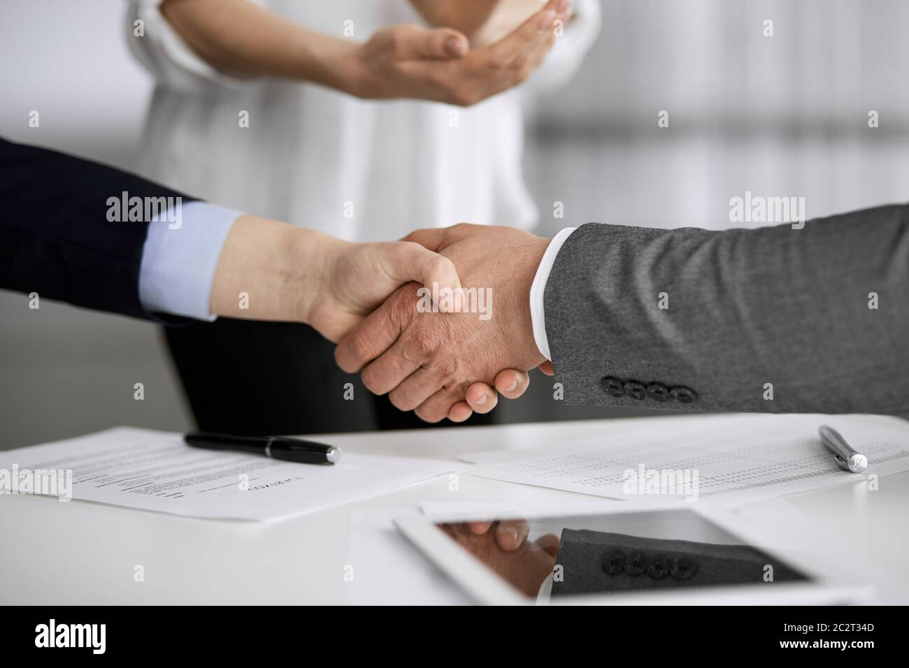 Business people shaking hands finishing contract signing, close-up ...