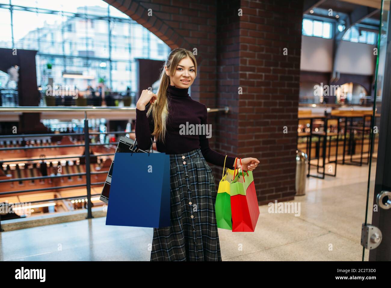 Female person with shopping bags in mall. Shopaholic in clothing store ...