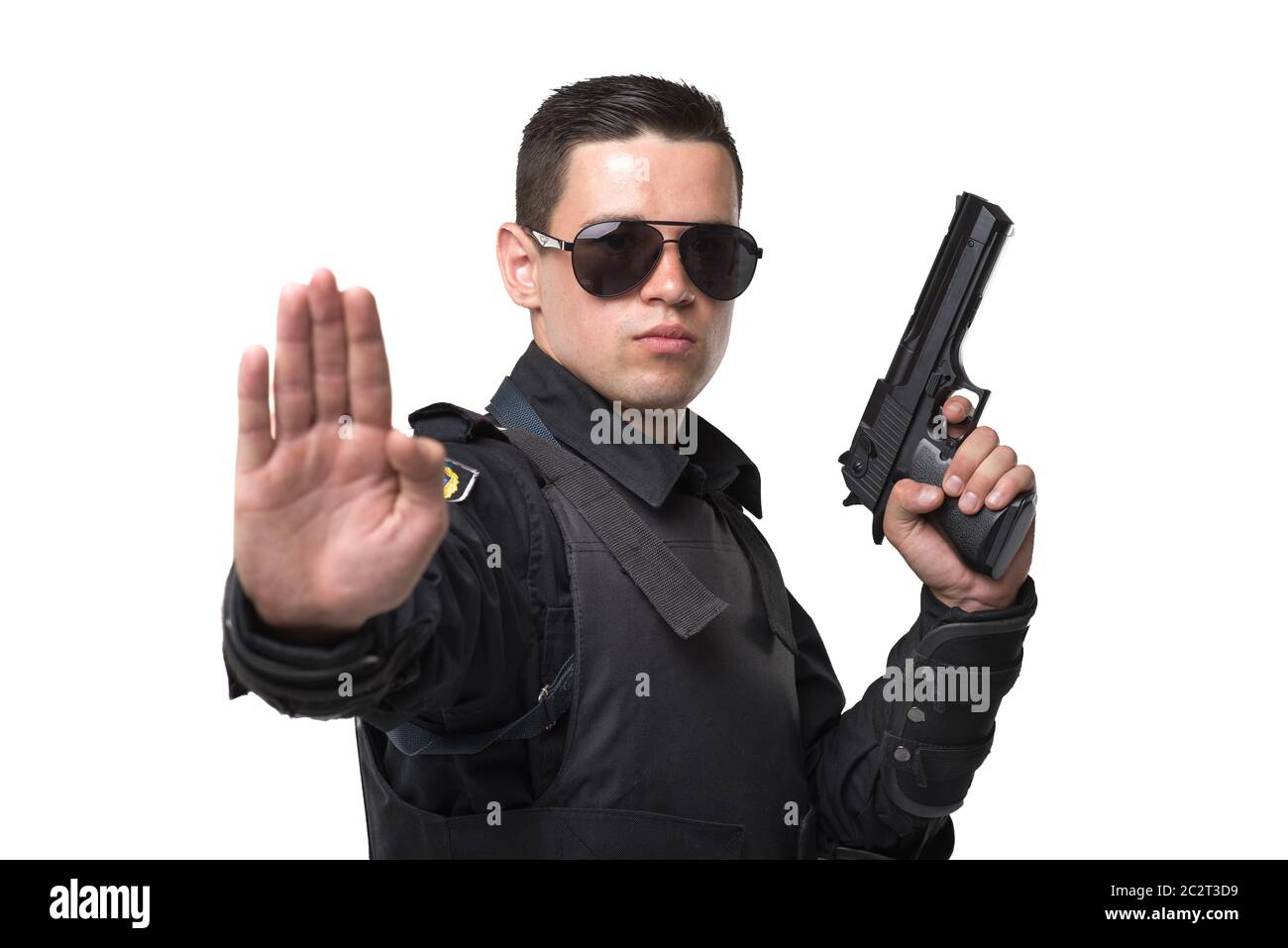 Seriuse cop in sunglasses poses with gun, black uniform with body armor ...