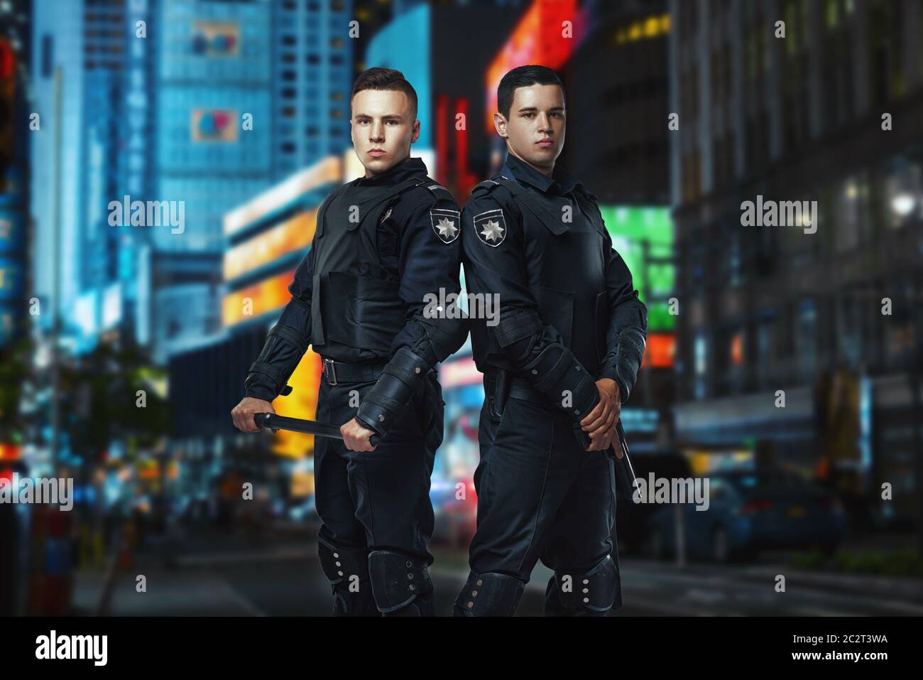 Two cops with a gun and a baton on the guard of the law, concept ...