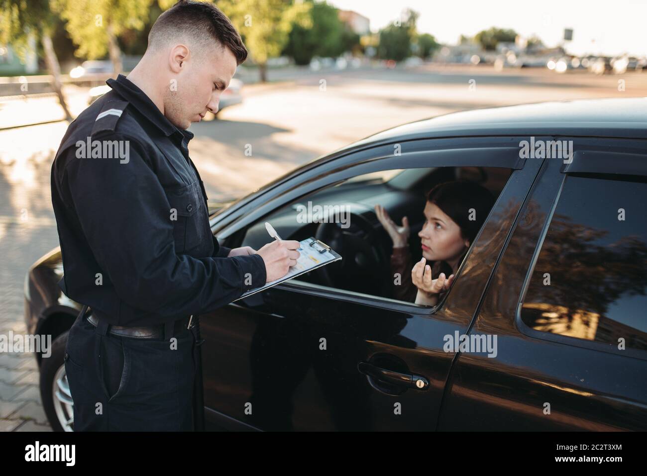 Male police officers in uniform check vehicle on the road. Law ...