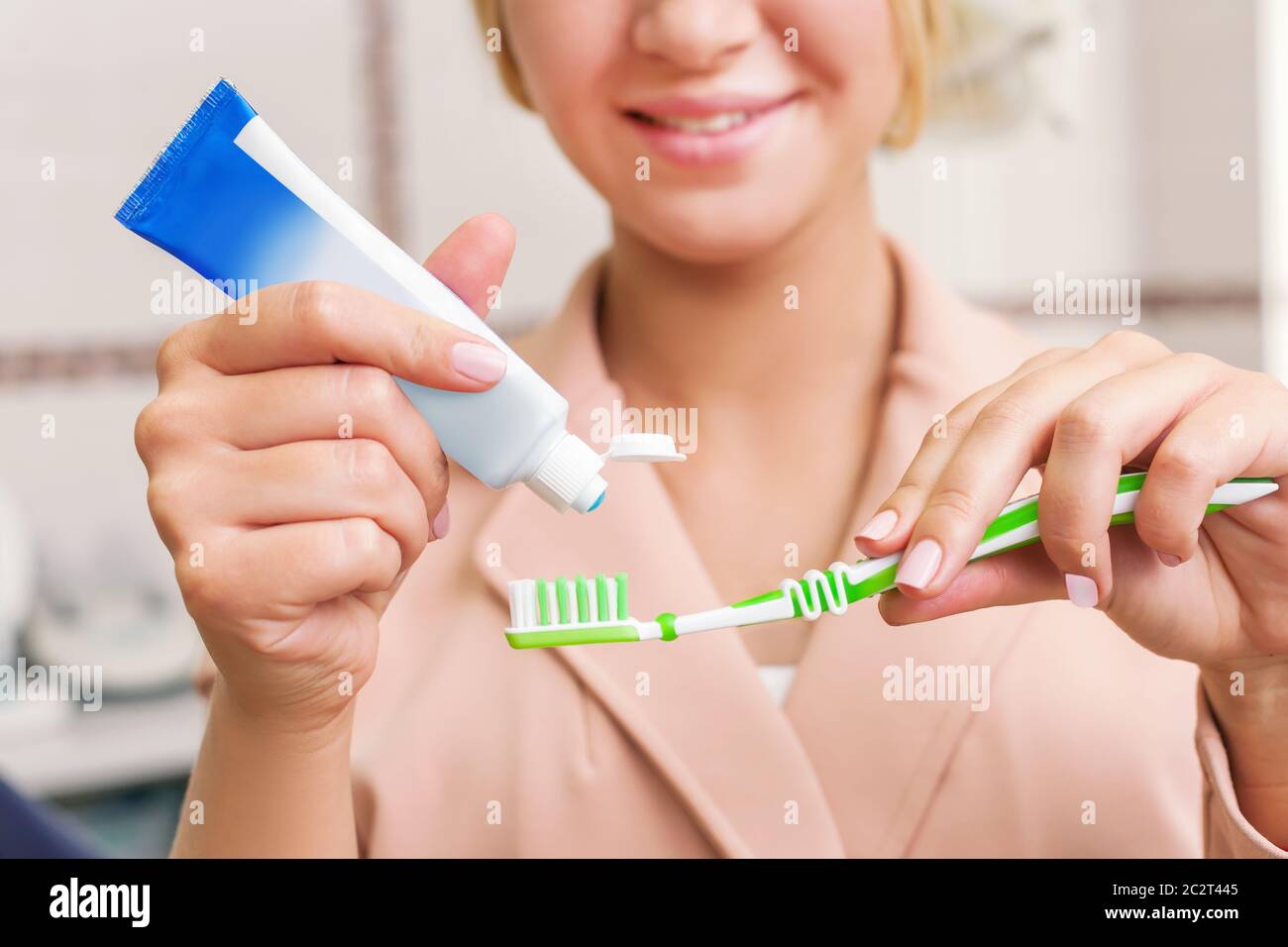 Woman putting toothpaste on the tooth brush Stock Photo - Alamy