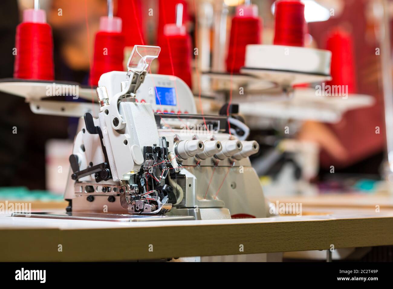 Overlock machine on sewing factory, nobody. Clothing sew. Textile ...