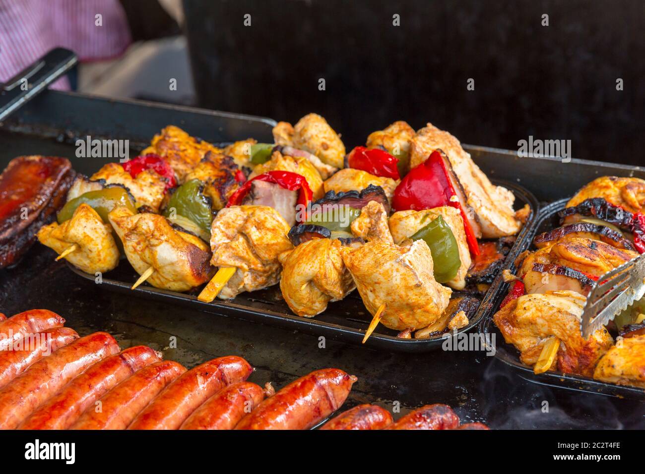 Fresh meat with vegetables on skewers in metal tray, dining room. Hotel ...