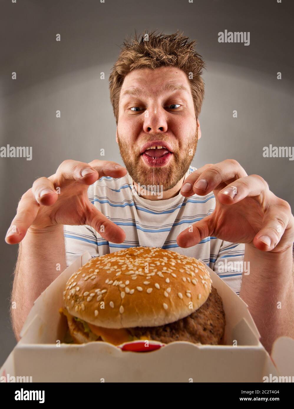 Portrait of happy man with leaking saliva preparing to eat burger Stock ...
