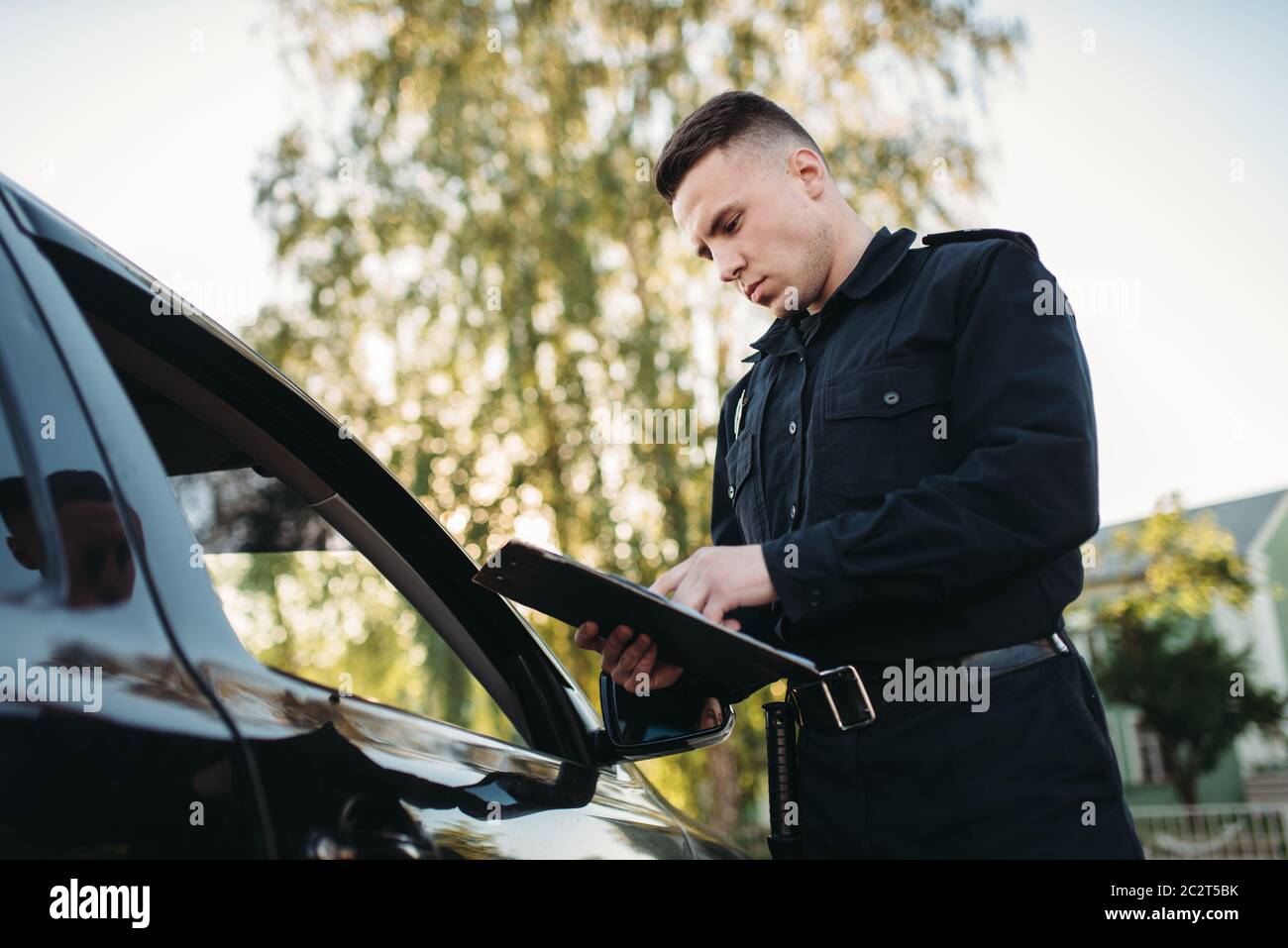 Female police officer writes ticket hi-res stock photography and images ...