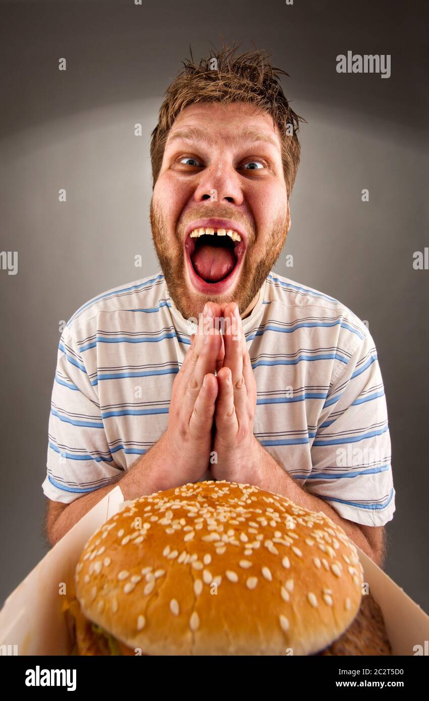 Portrait of happy man praying for fast food Stock Photo - Alamy