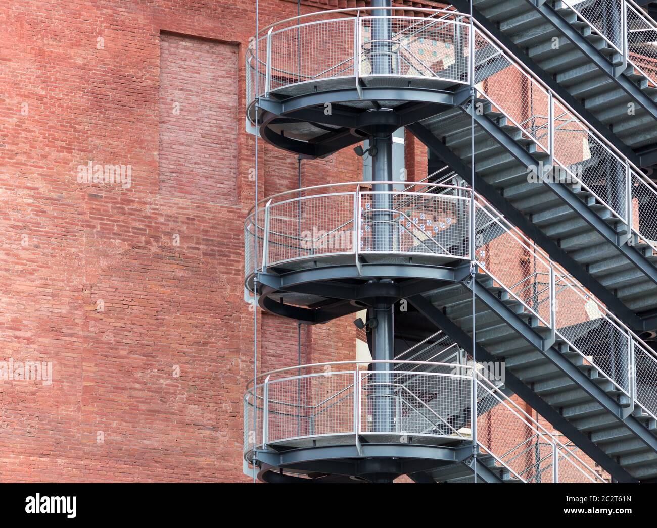 Curved stairs against brick wall Stock Photo - Alamy