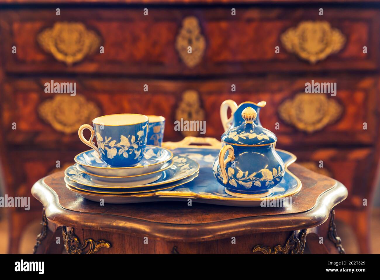 Set of ancient tableware on wooden table in museum, Europe, nobody. Old ...