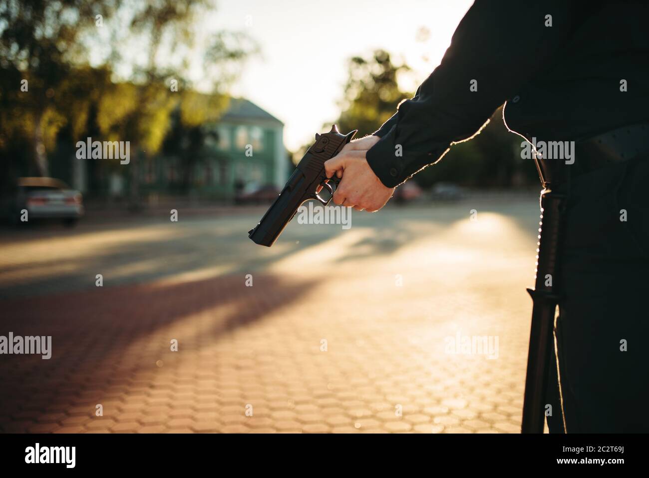 Male cop in uniform with gun in hands. Police officer with weapon. Law ...