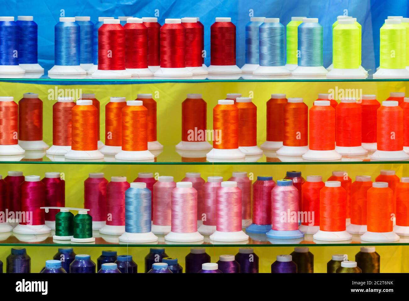 Spools of new color threads, sewing equipment. Cloth factory, weaving ...