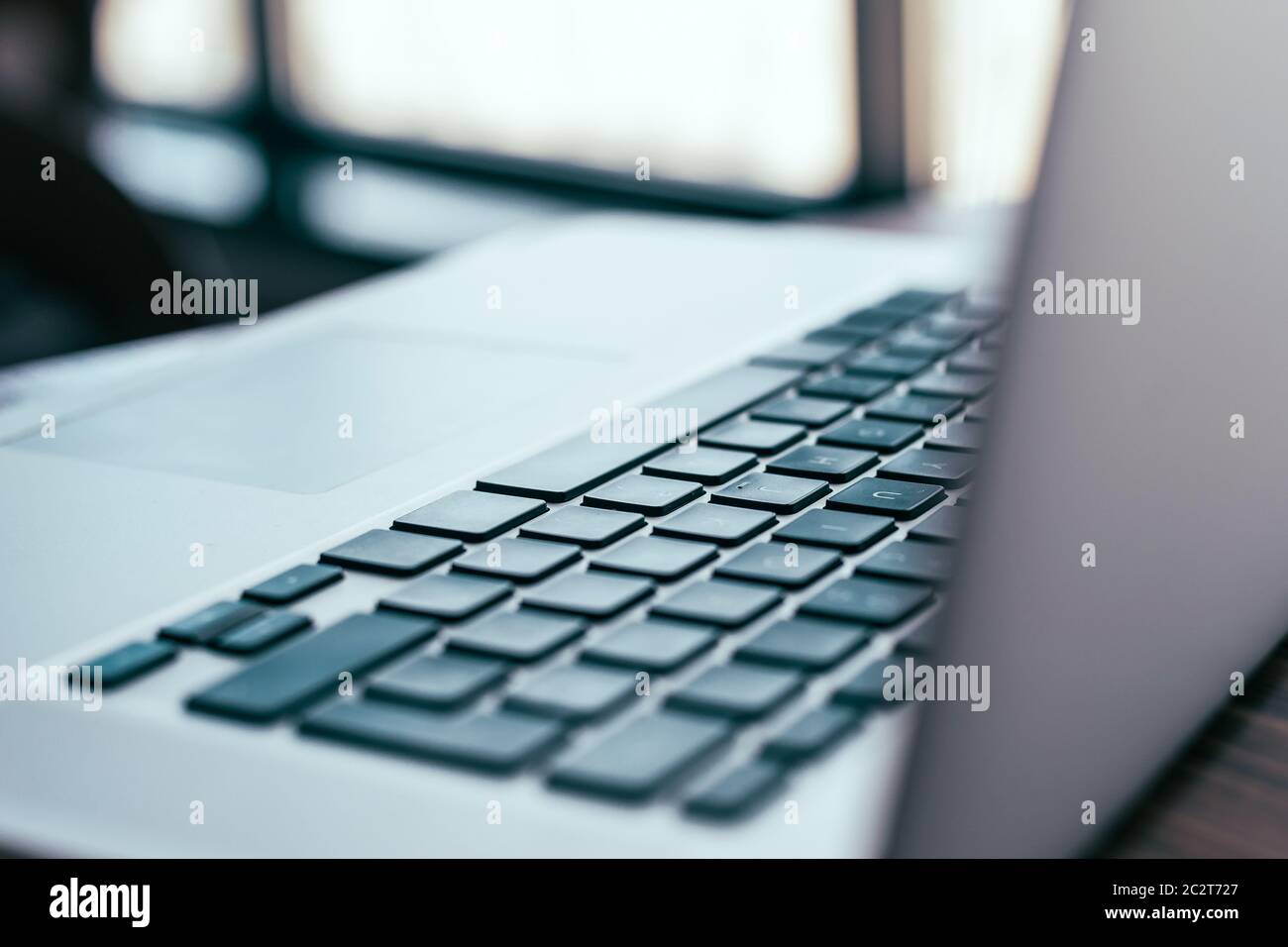 side view. open laptop on the desktop Stock Photo - Alamy