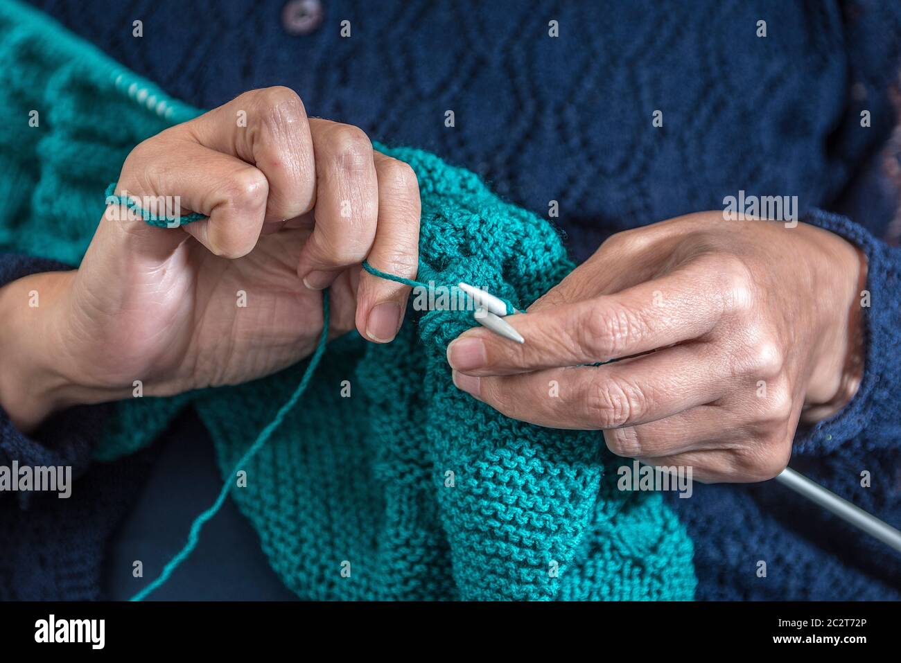 A womans hands knitting with wool Stock Photo - Alamy