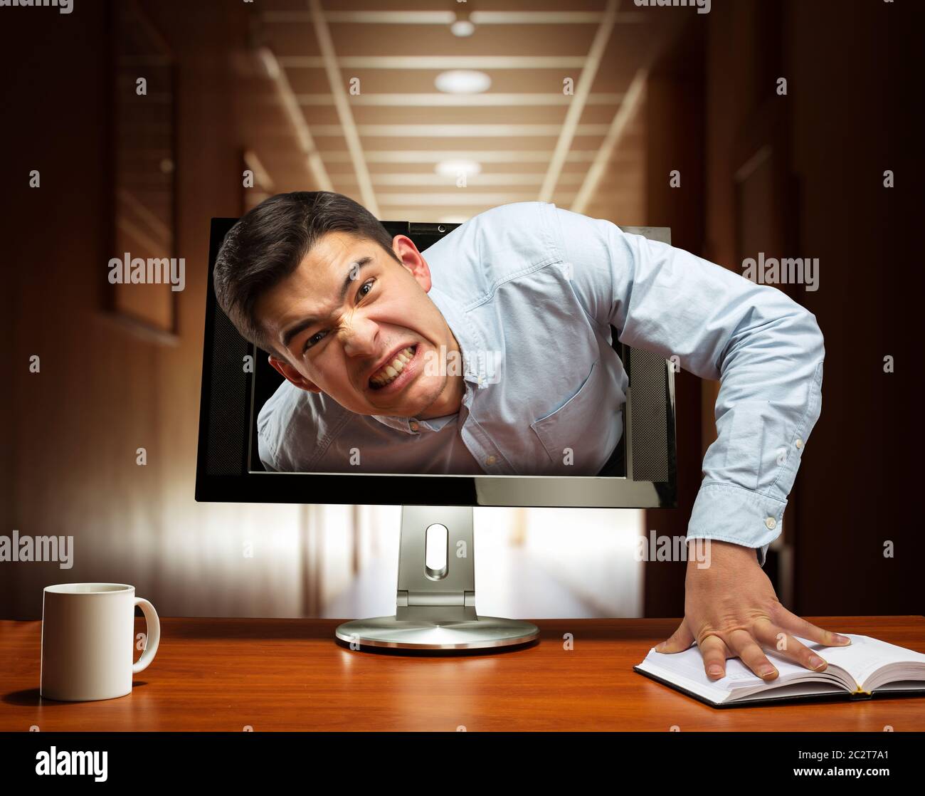 Angry businessman getting out from the computer screen Stock Photo - Alamy
