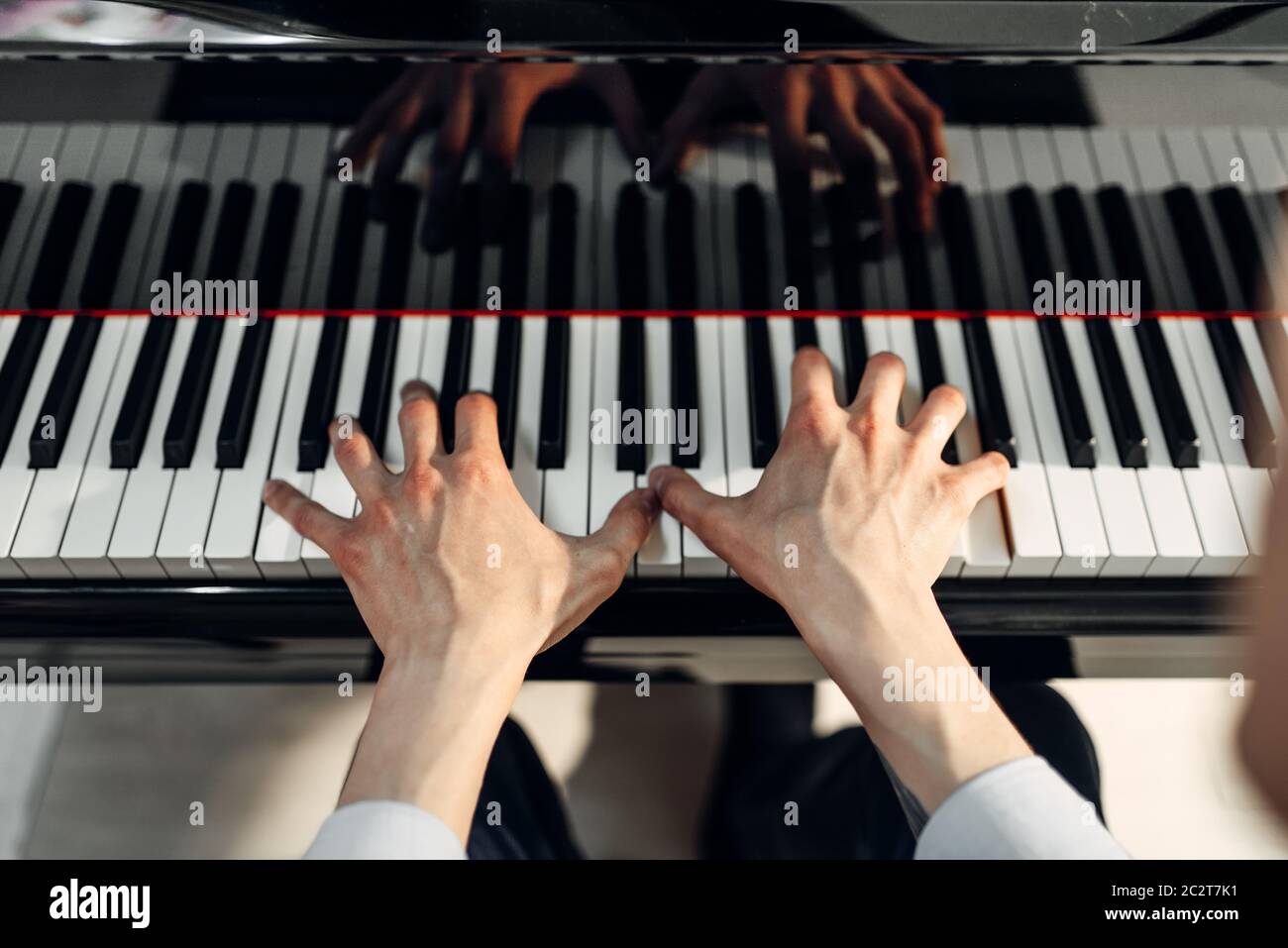 Male pianist hands on grand piano keyboard, top view. Musician ...