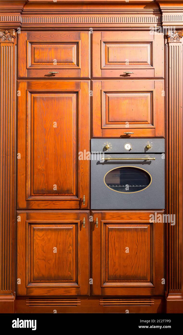 Kitchen wooden furniture with an oven built in Stock Photo - Alamy