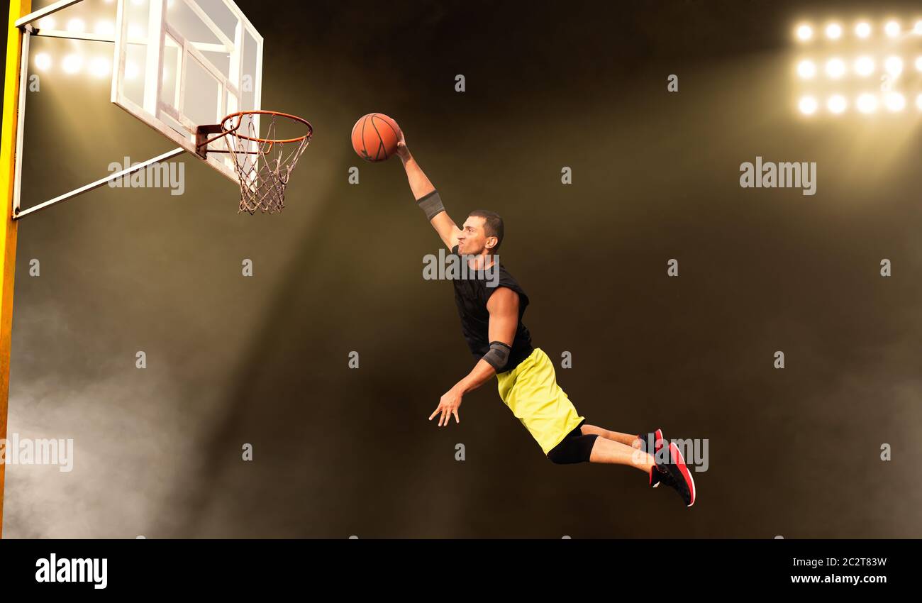 Basketball player makes a throw, shoot in action, dark background. Male ...