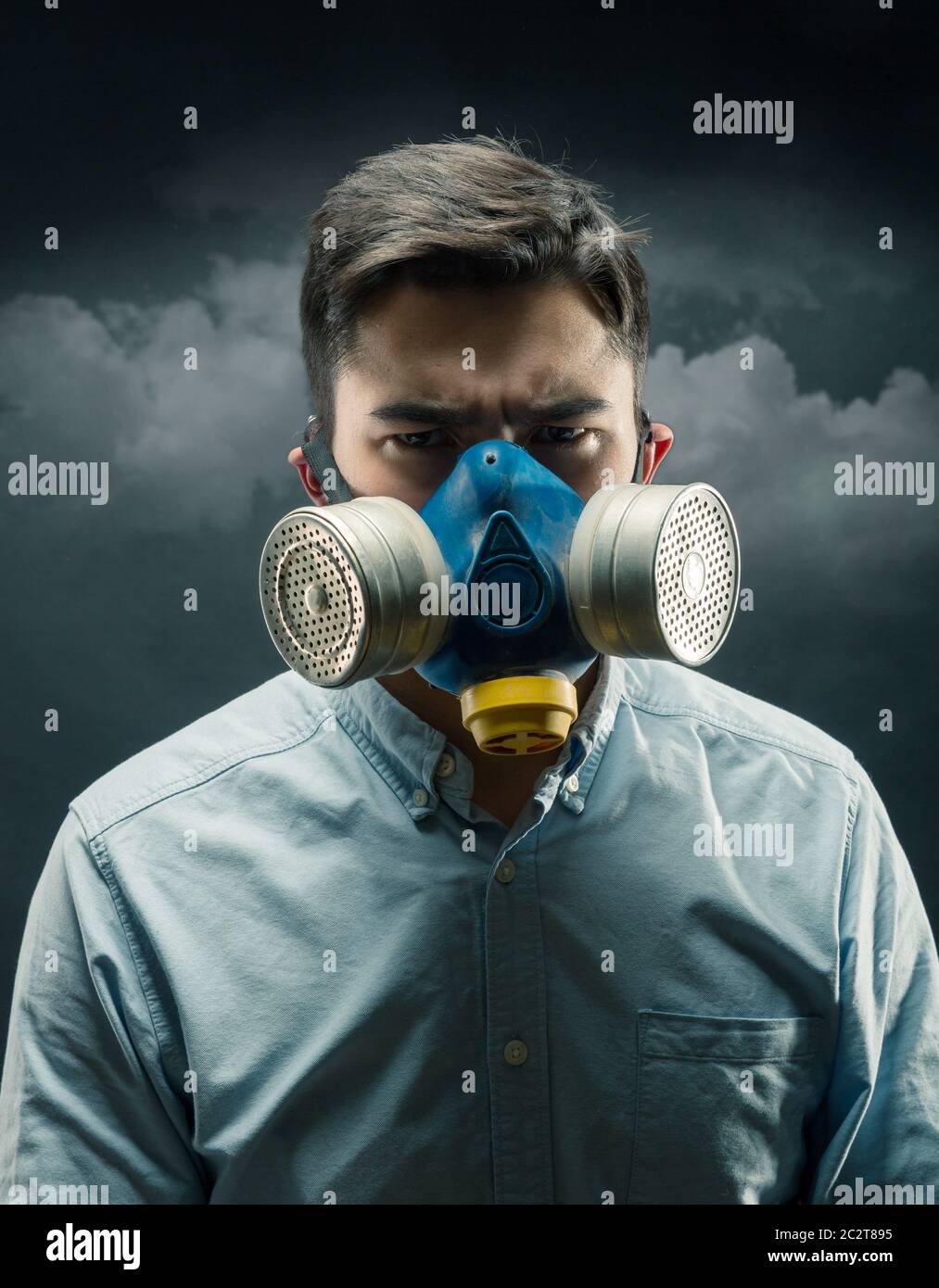 Young man in a gas-mask with atmospheric pollution Stock Photo - Alamy