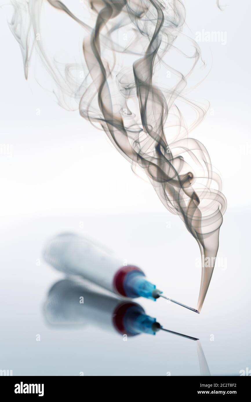 Syringe and smoke on white Stock Photo - Alamy