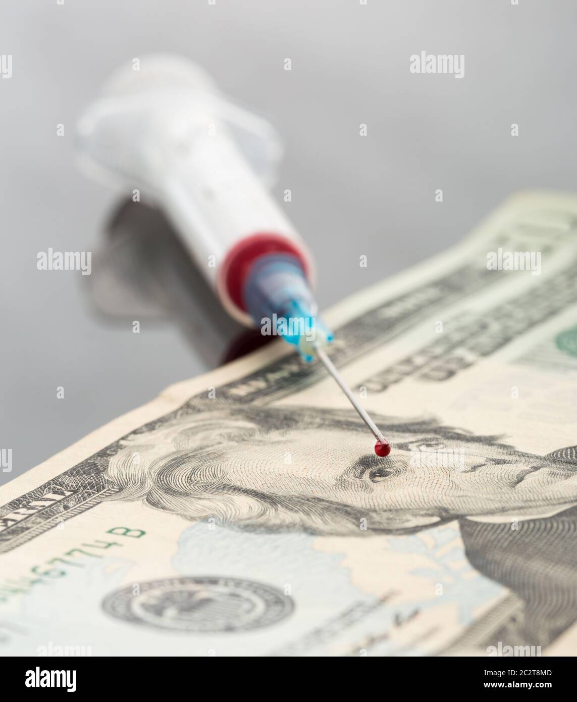 Syringe with blood drop on dollar note Stock Photo - Alamy