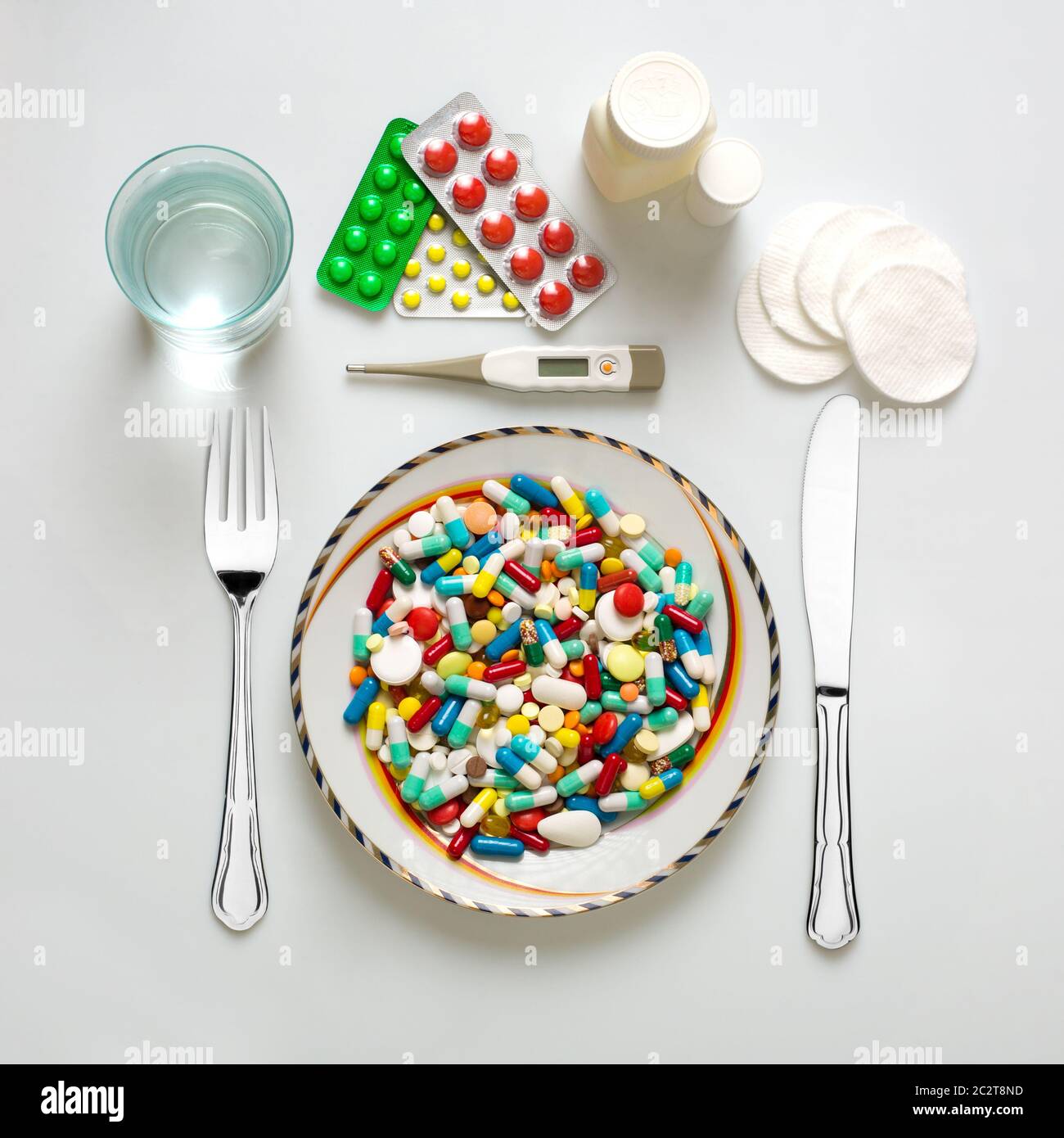 Medical dinner set with silverware and pills Stock Photo - Alamy