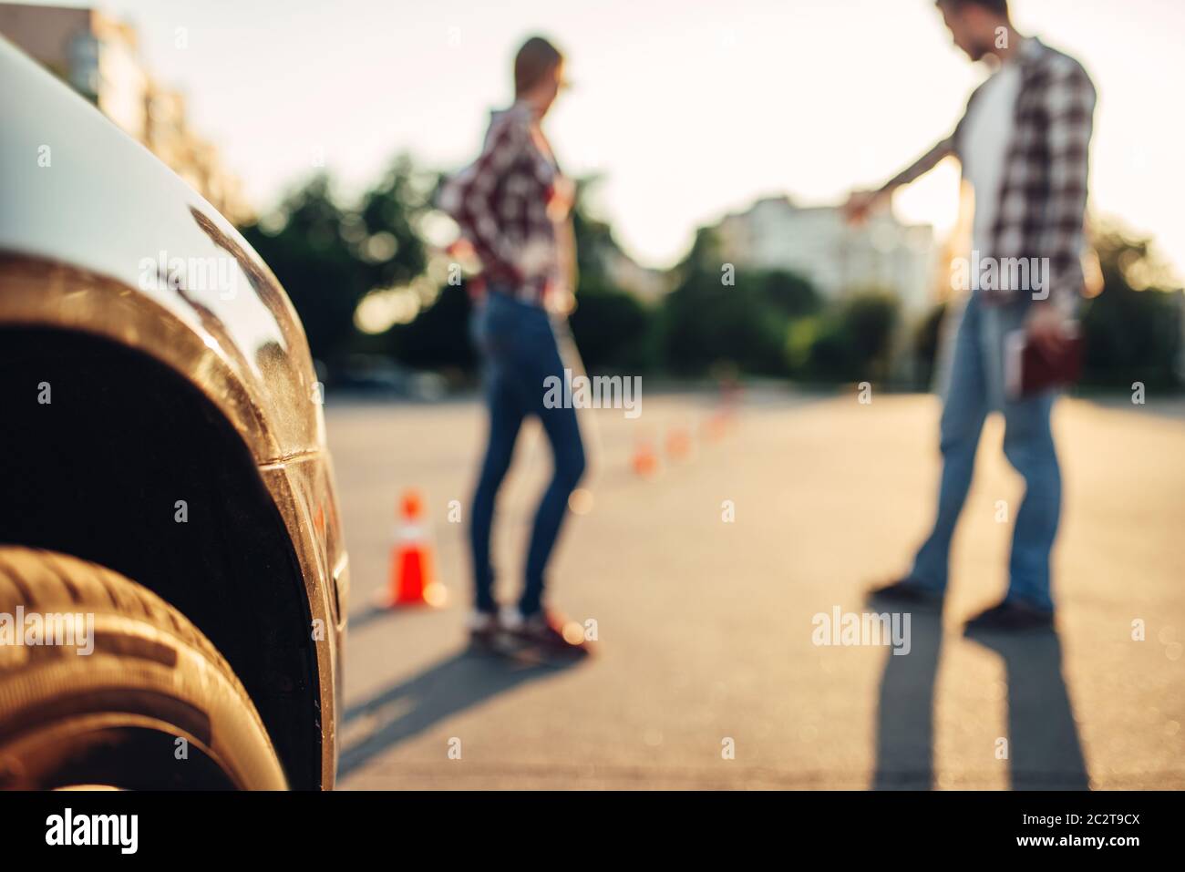 Male instructor and woman student, exam for novice car drivers, driving ...