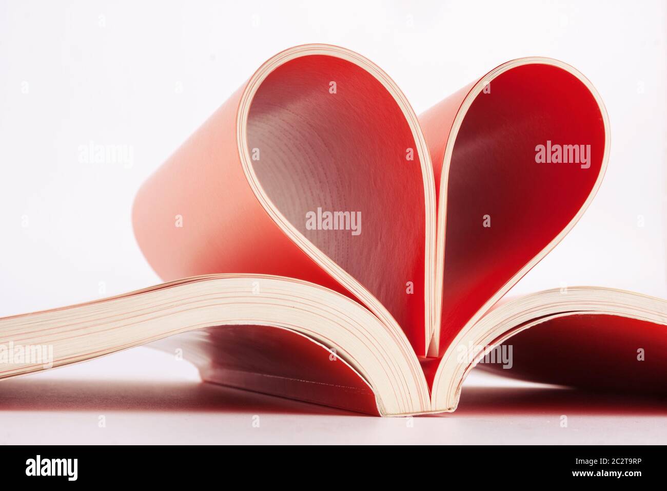 Red book pages folded into a heart shape closeup Stock Photo - Alamy