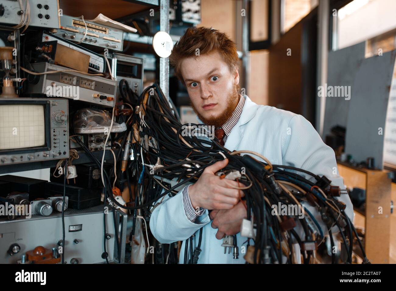 Strange engineer holds bunch of wires with different plugs in ...