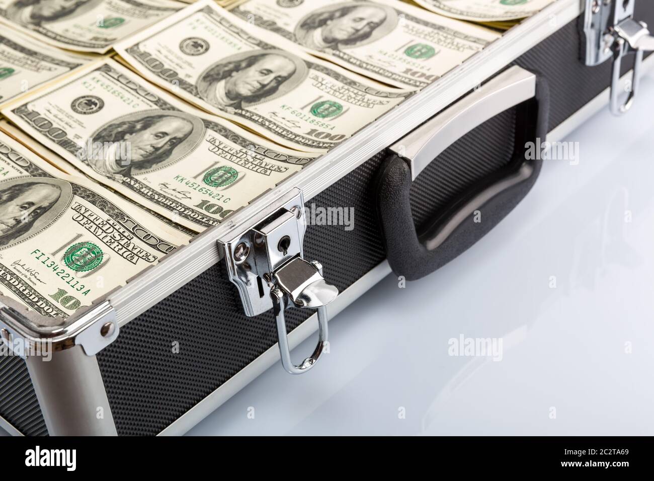 Case full of dollar cash on white background Stock Photo - Alamy