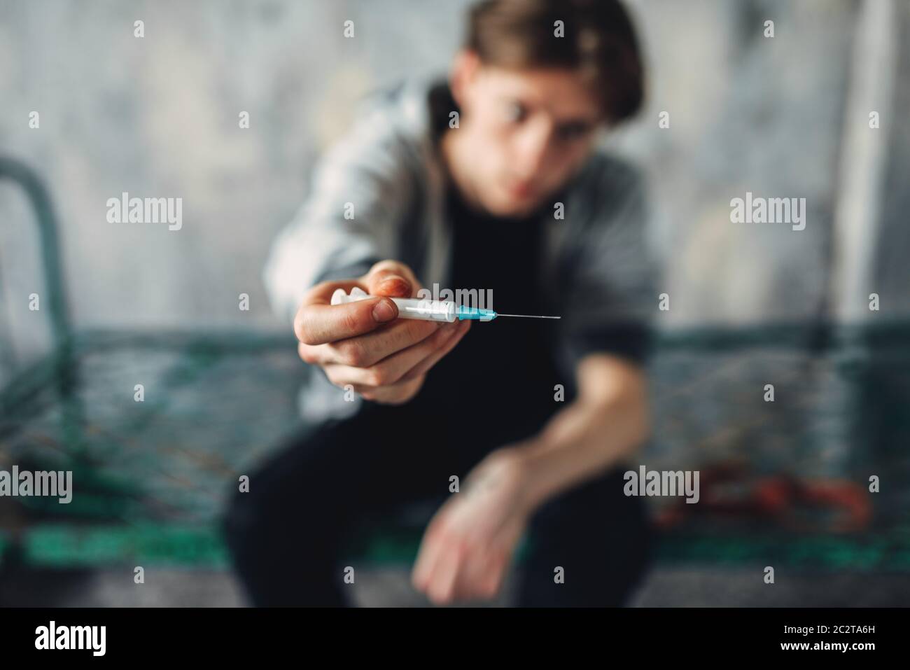 Male junkie reaching out hand with syringe. Drug addiction concept ...