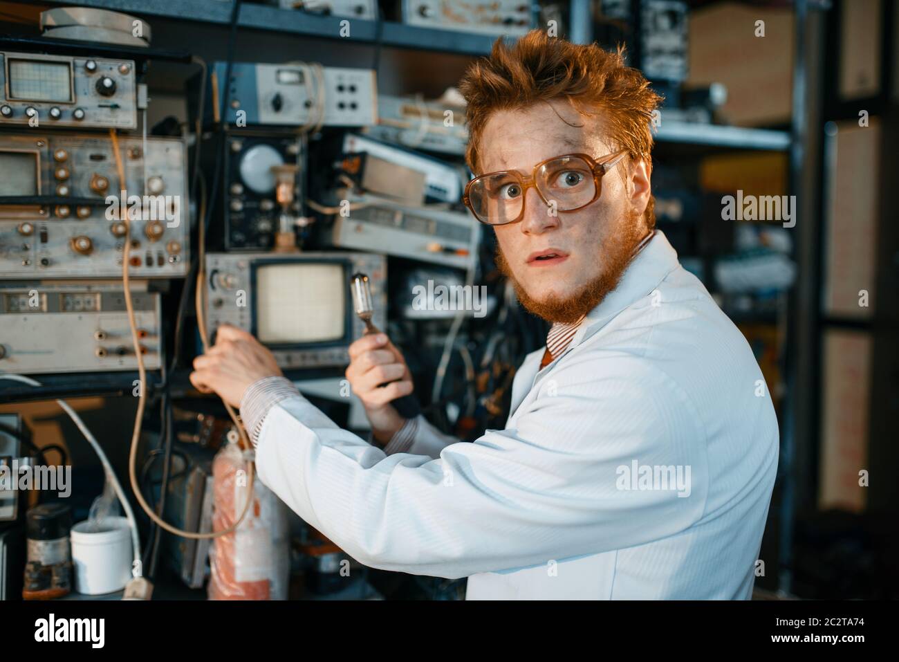 Strange engineer holds electric tube in laboratory. Electrical testing ...