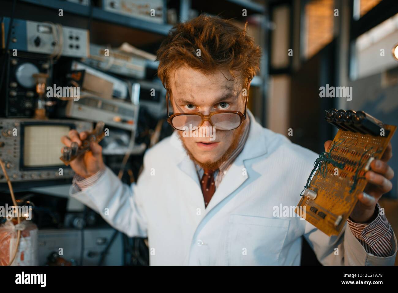 Strange engineer holds electric tube in laboratory. Electrical testing ...