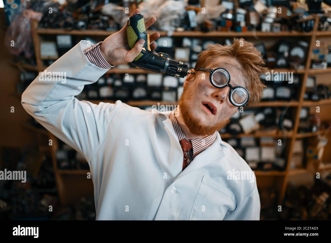 Strange scientist holds screwdriver at his temple, dangerous test in ...