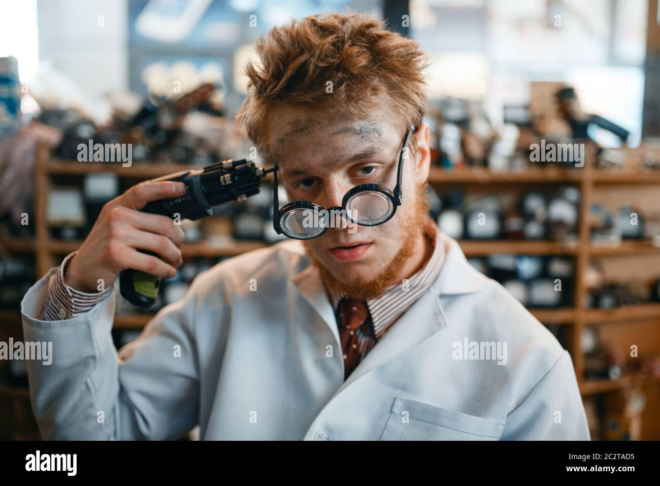Strange scientist holds screwdriver at his temple, dangerous test in ...