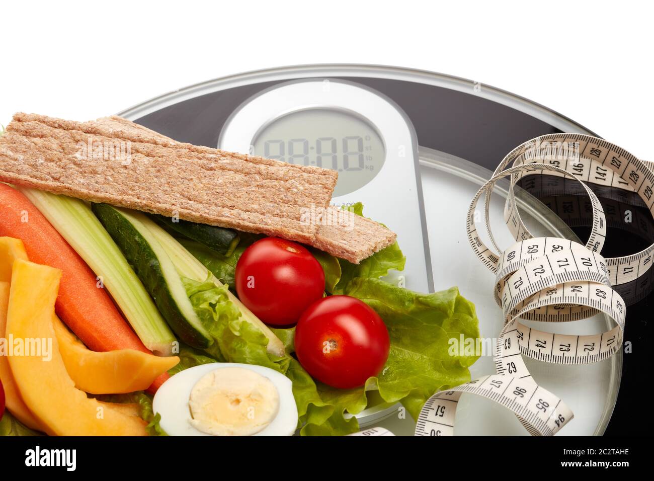 Still life with healthy food, scales and measuring tape on white ...