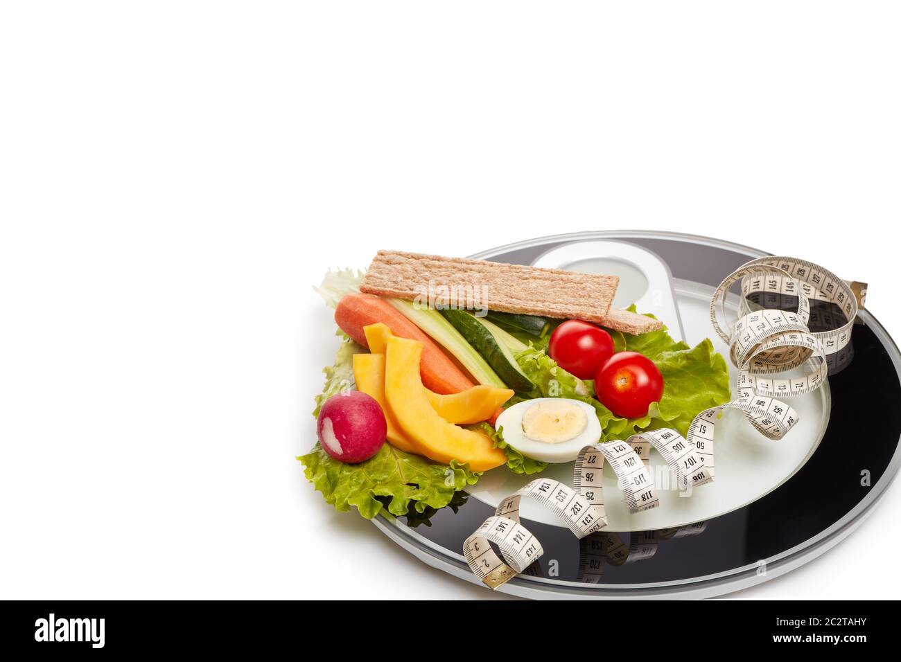 Still life with healthy food, scales and measuring tape on white ...