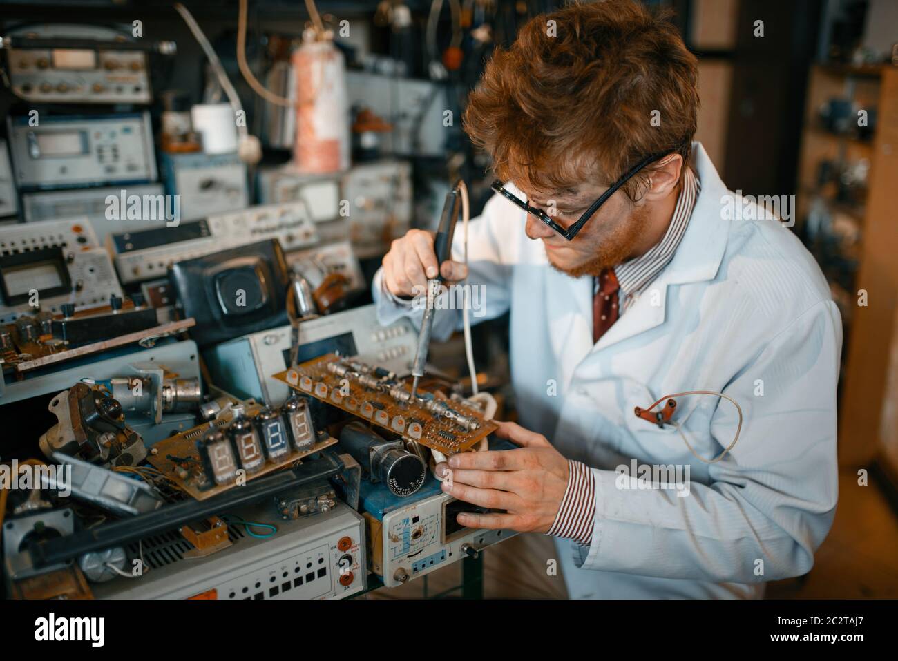 Strange scientist soldering chips, test in laboratory. Electrical ...