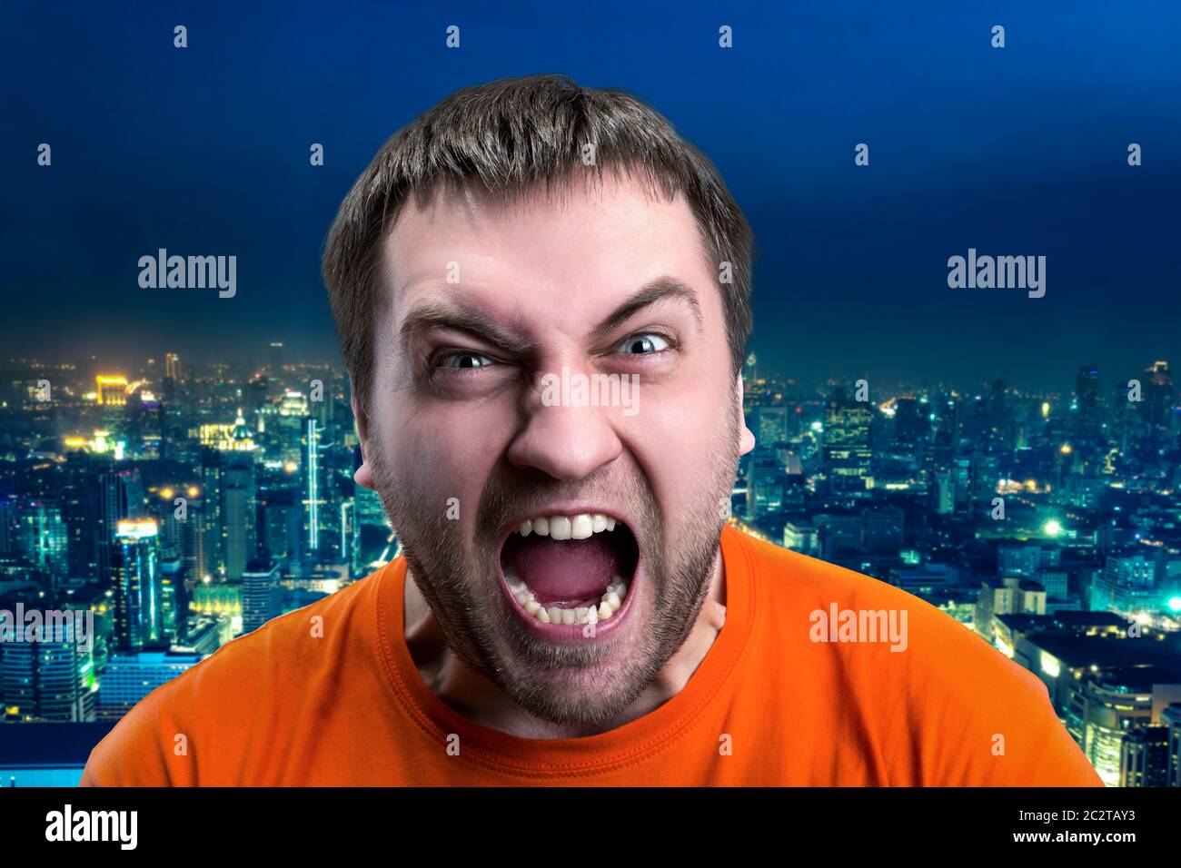 Angry man screaming against night city Stock Photo - Alamy