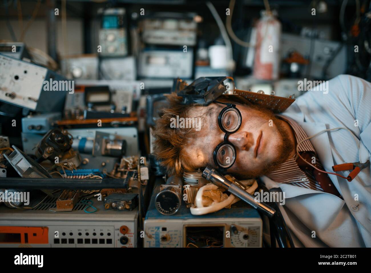 Strange engineer sleeping on devices in laboratory. Electrical testing ...