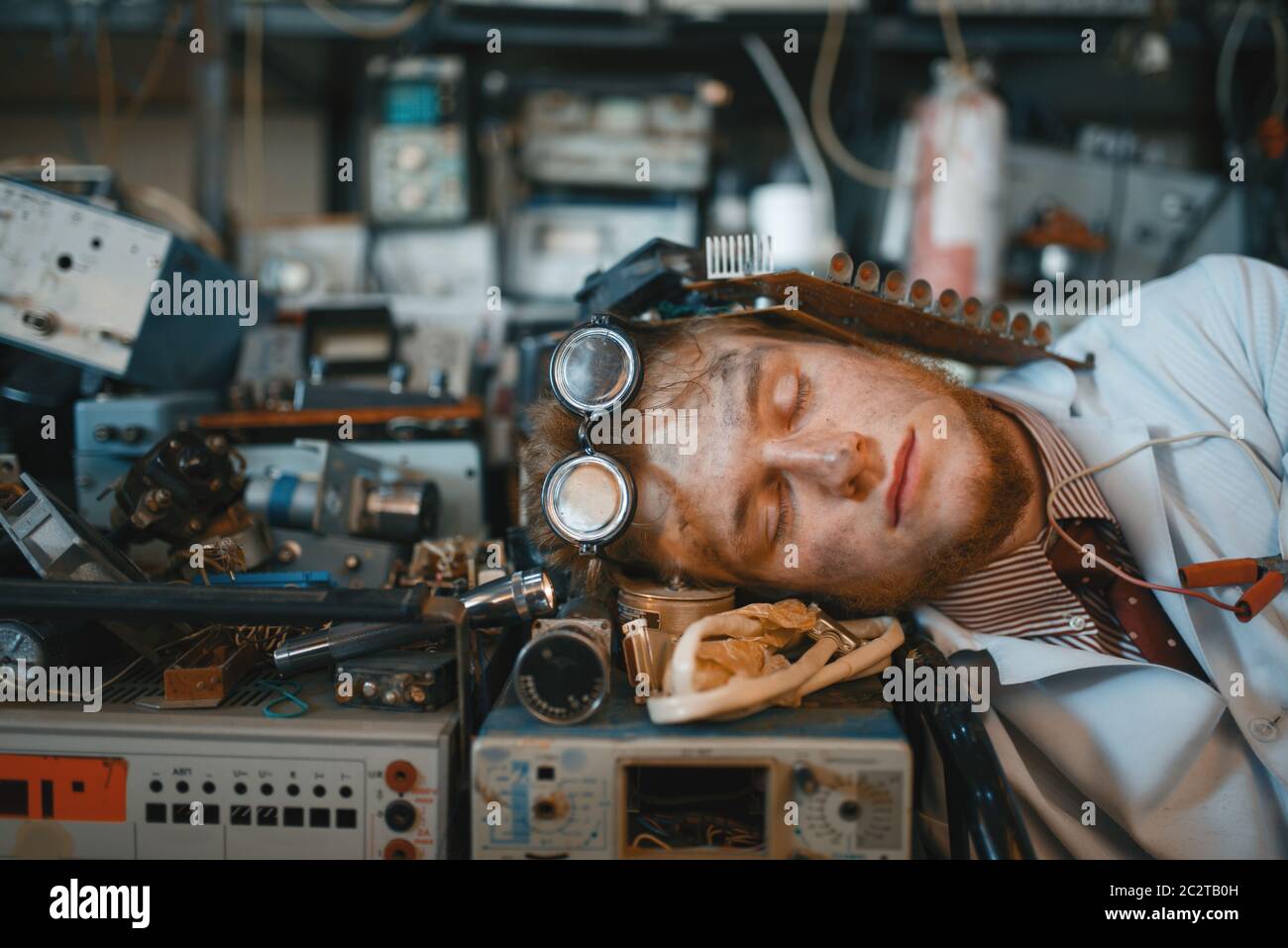 Strange engineer sleeping on devices in laboratory. Electrical testing ...