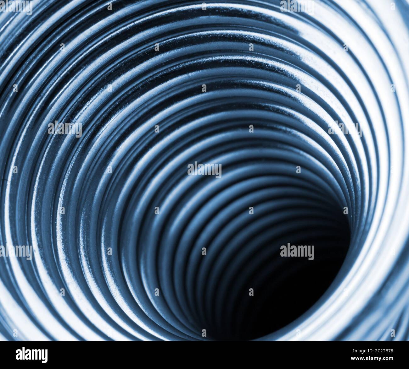 Inside the coiled metal springs. Toned in blue Stock Photo - Alamy