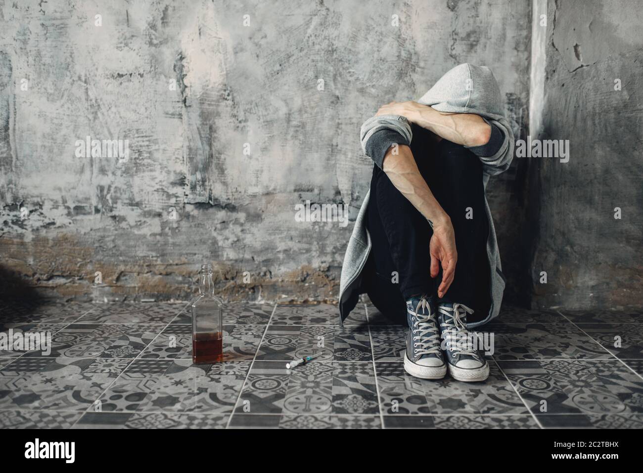 Depressed druggy sitting on the floor, withdrawal symptom. Narcotic ...