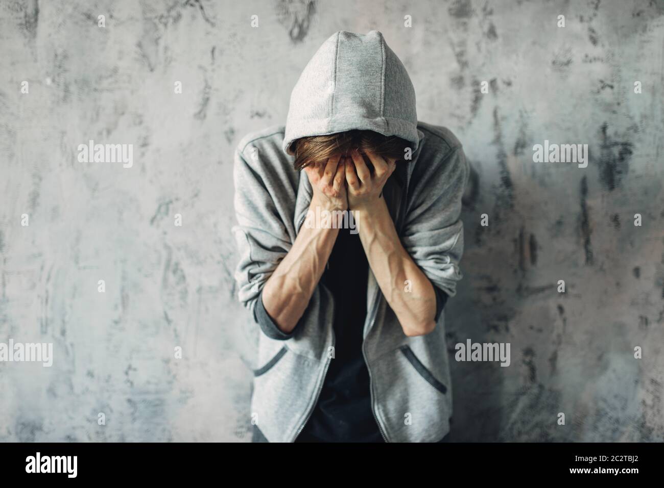 Depressed druggy sitting on the floor, withdrawal symptom. Narcotic ...