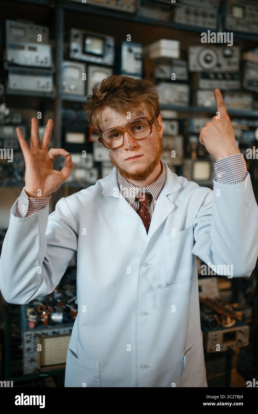 Strange male scientist shows signs with his fingers in laboratory ...
