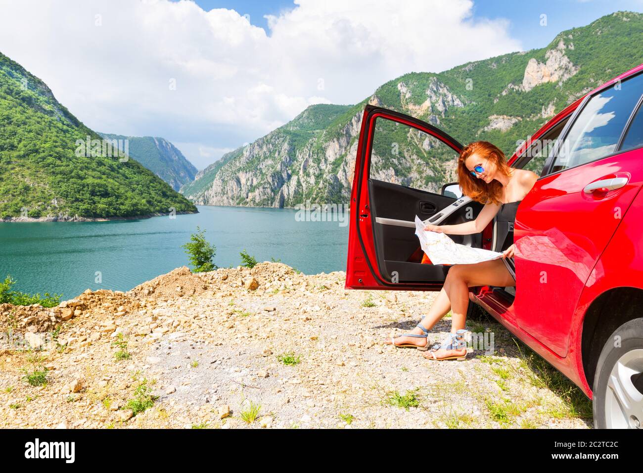 Girl is reading a map in mountains Stock Photo - Alamy