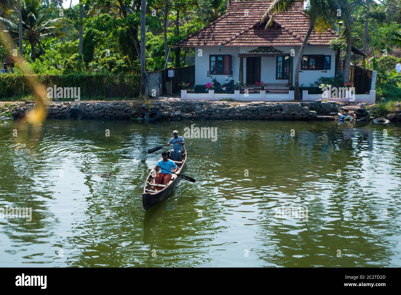 Small houses in a local village located next to Kerala's backwater on a ...