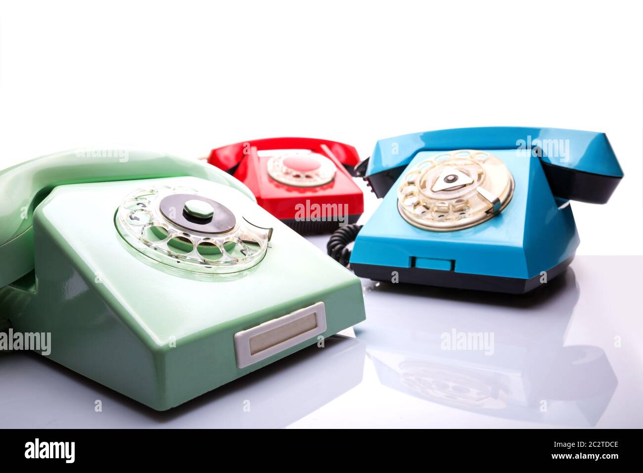 Three vintage telephones isolated over white background Stock Photo - Alamy