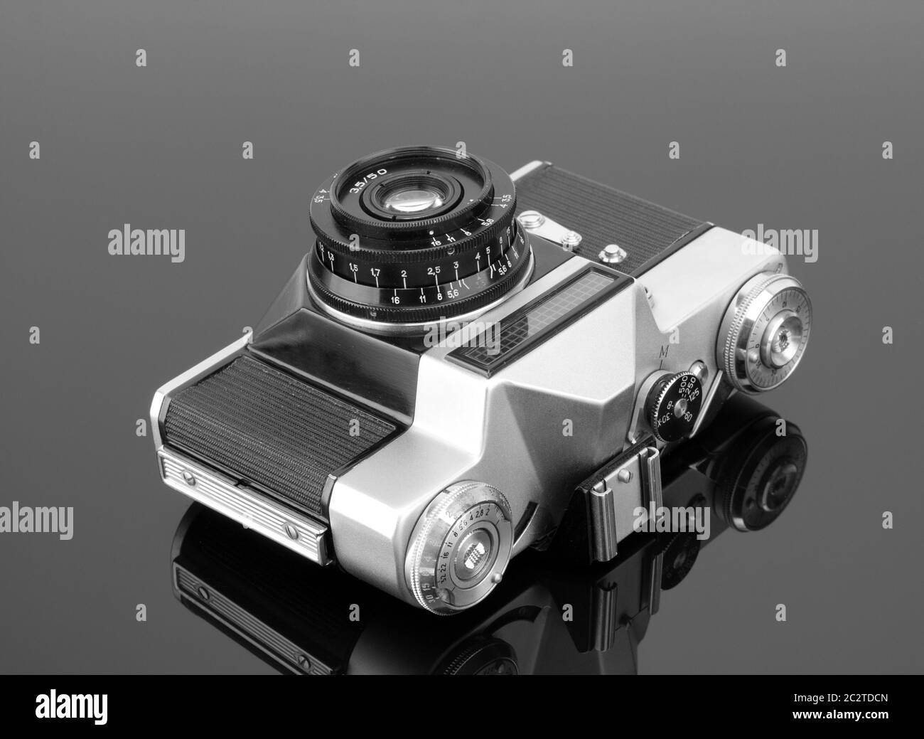 Old photographic camera on gray reflective surface Stock Photo - Alamy