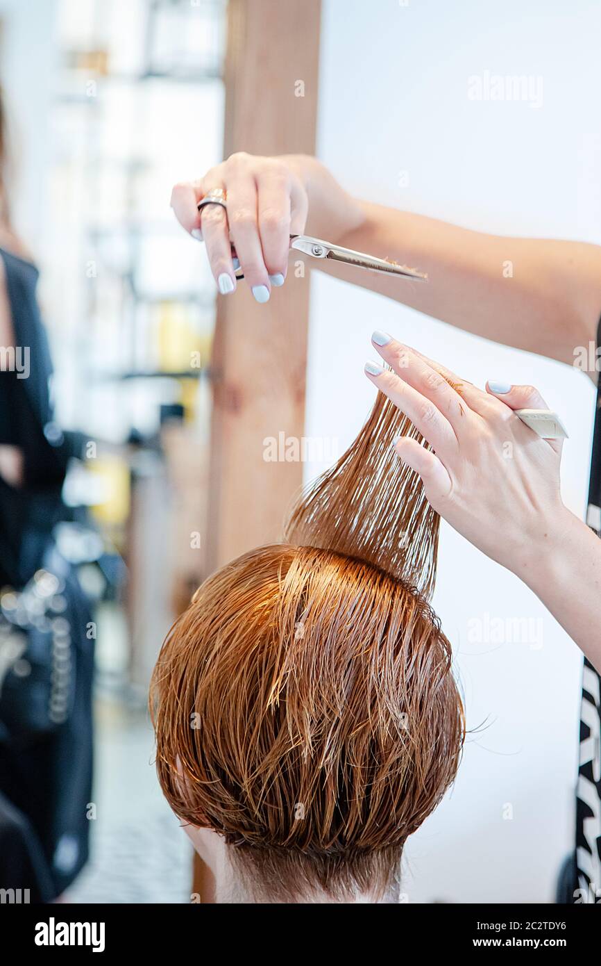 Close up of a masculine hand cutting hair with scissors Stock Photo - Alamy